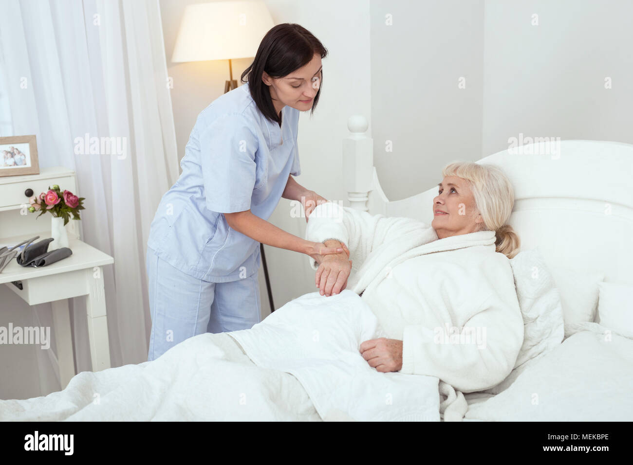 Healthcare professional comforting elderly hi-res stock photography and ...
