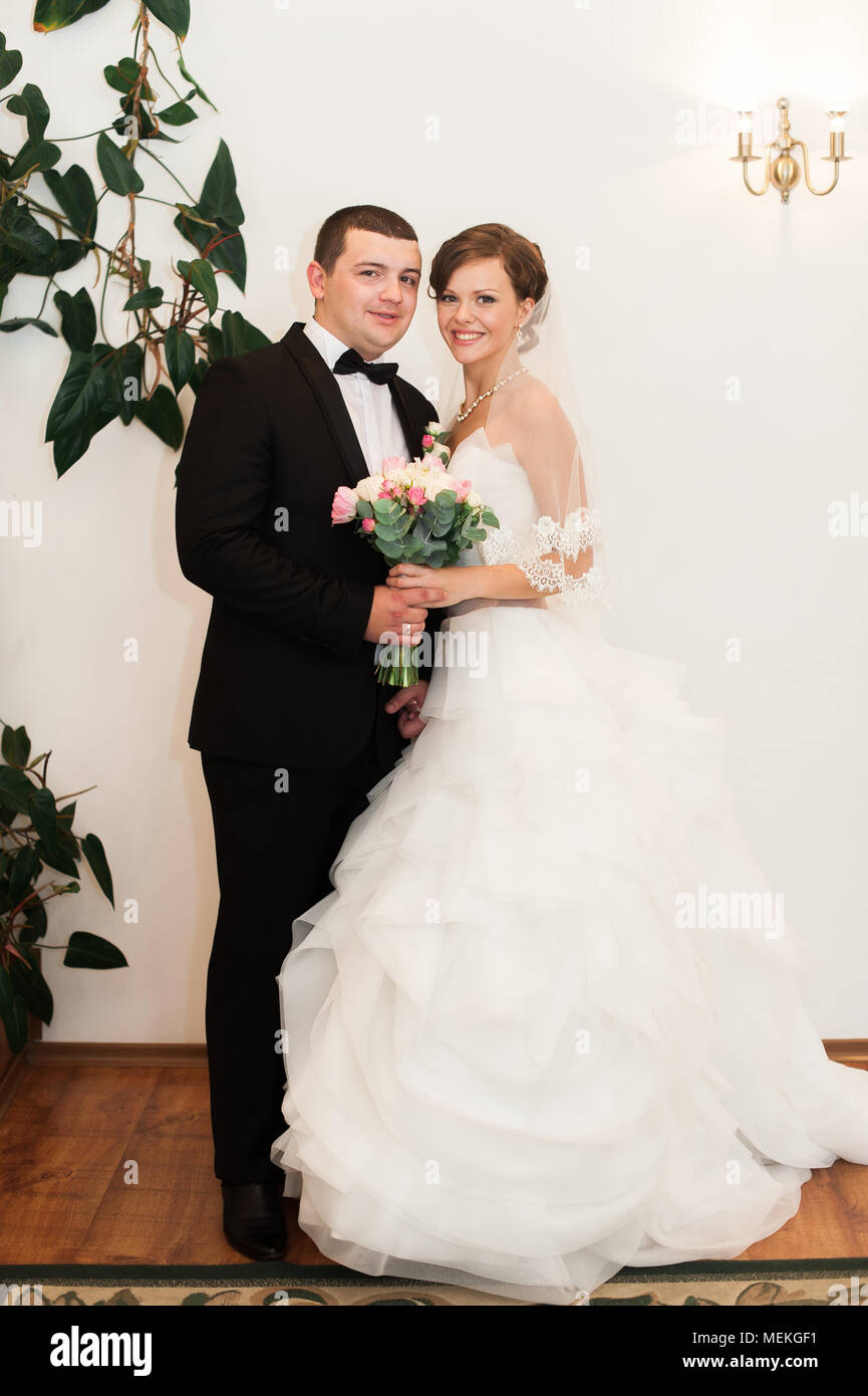 Bride and groom on marriage registration. The groom looks at the bride ...