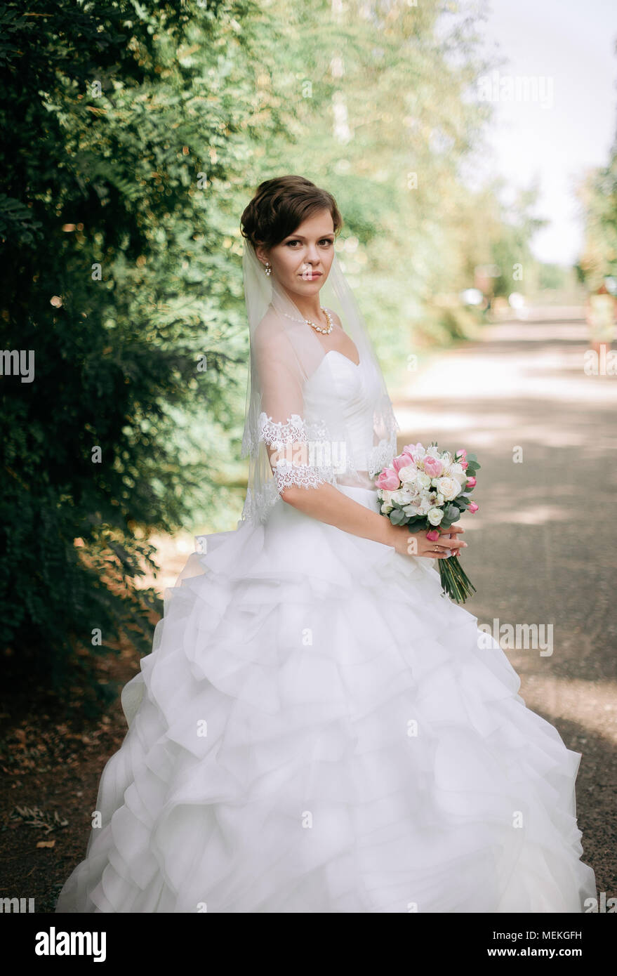 Beautiful bride woman portrait with bridal bouquet posing in her ...
