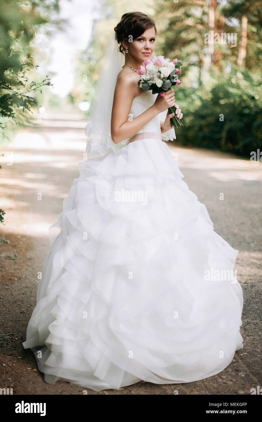 Beautiful bride woman portrait with bridal bouquet posing in her ...