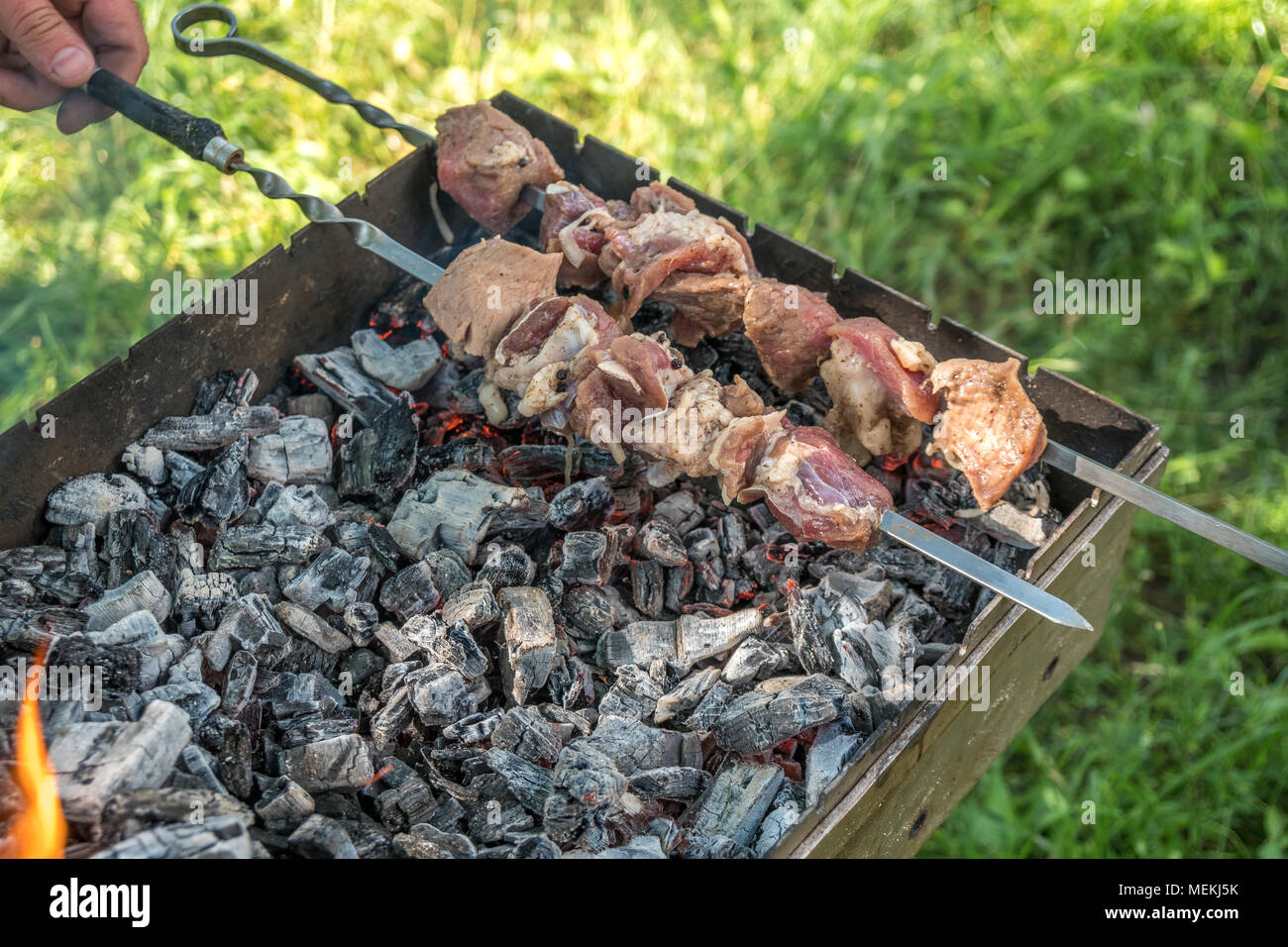 Georgian mtsvadi (Shashlik) preparation. Smoking shashlik on the grill ...