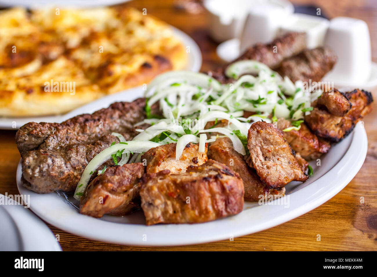 Traditional Georgian mtsvadi pork barbecue and Kebab with onion and ...