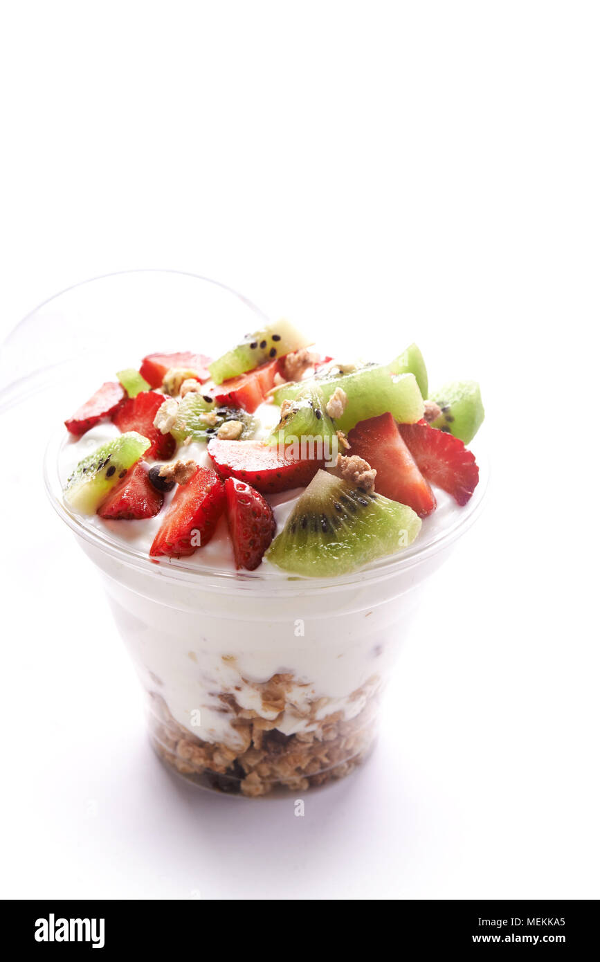 granola with yoghurt and berries in bowl over white background Stock ...