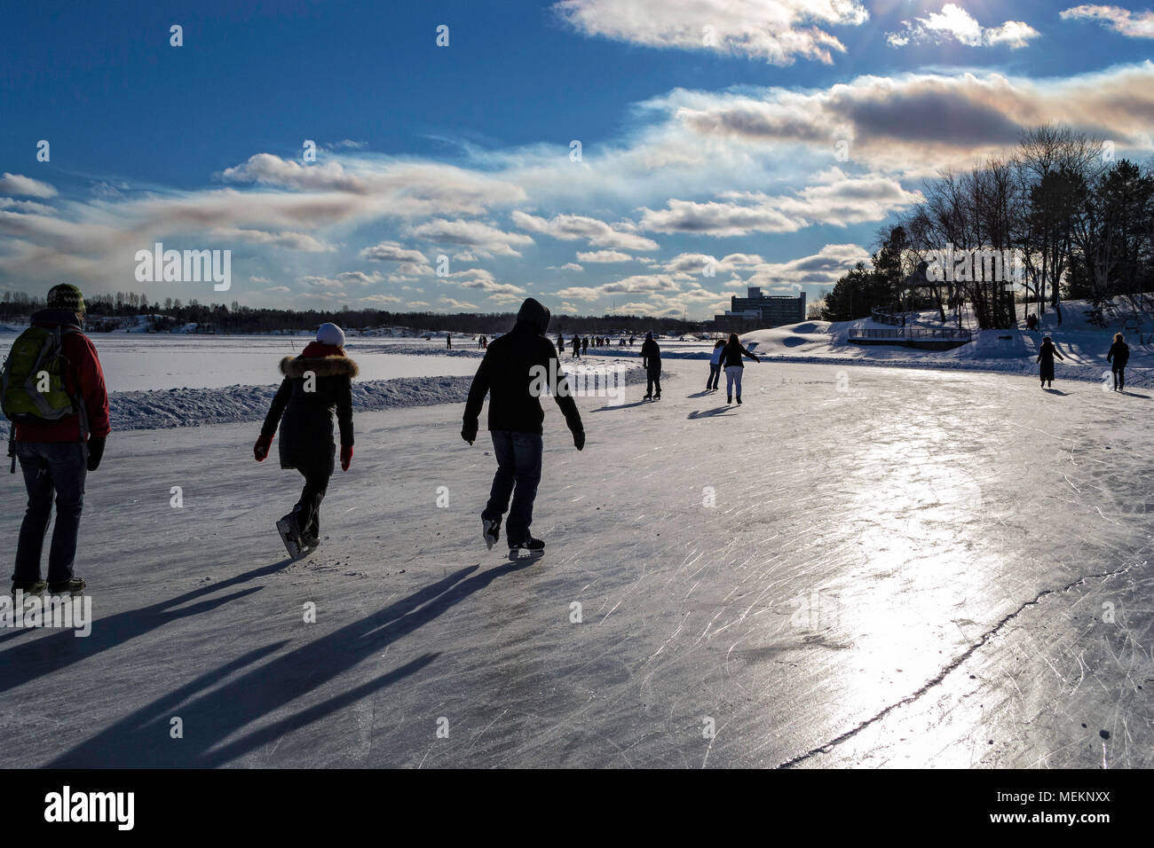 Skaters enjoying a sunny day on the skating path on Ramsey lake ...