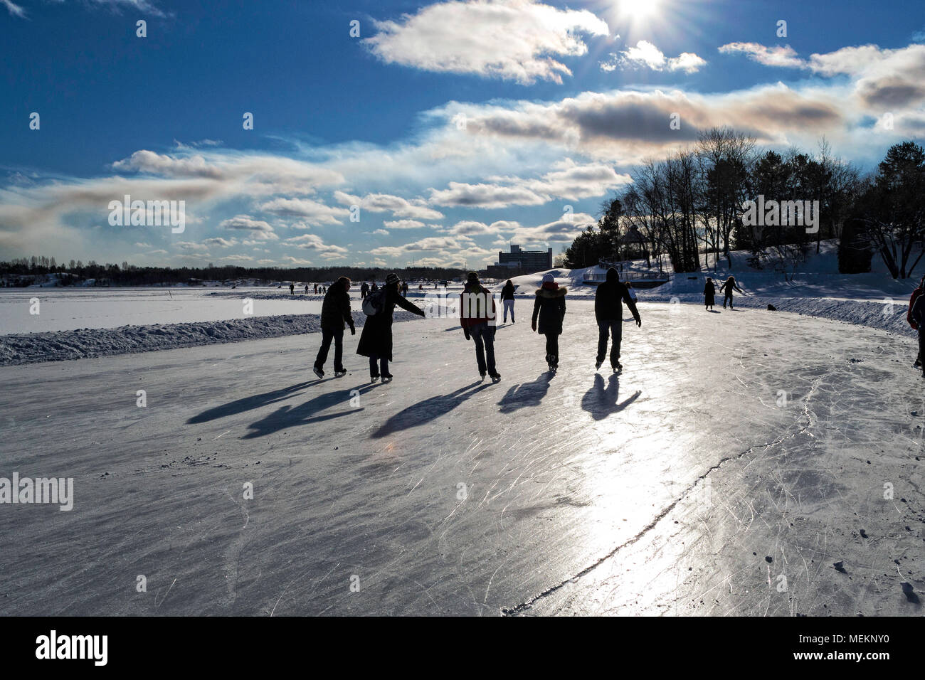 Skaters enjoying a sunny day on the skating path on Ramsey lake ...