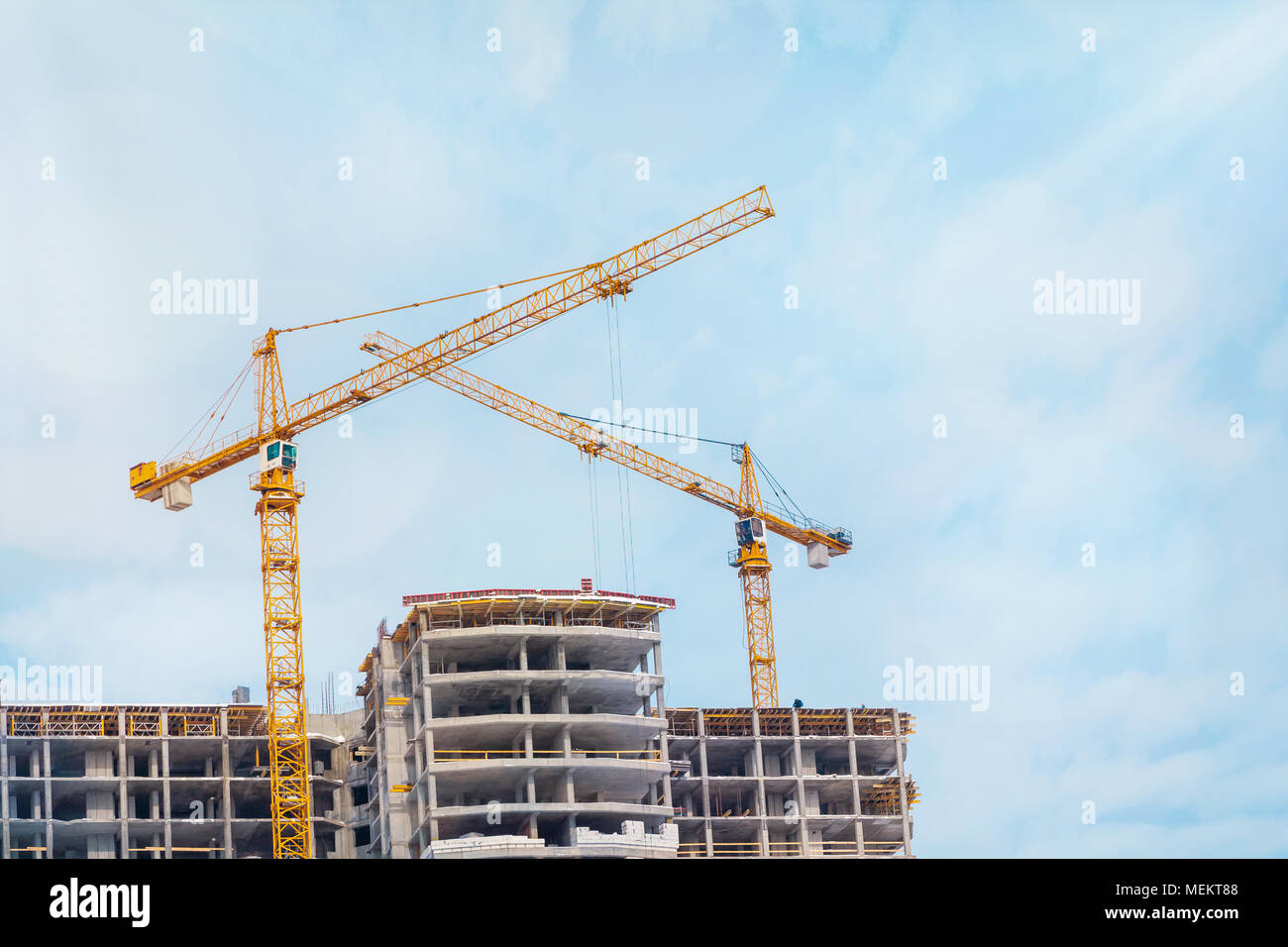 Two yellow cranes during work, concept of building business Stock Photo ...