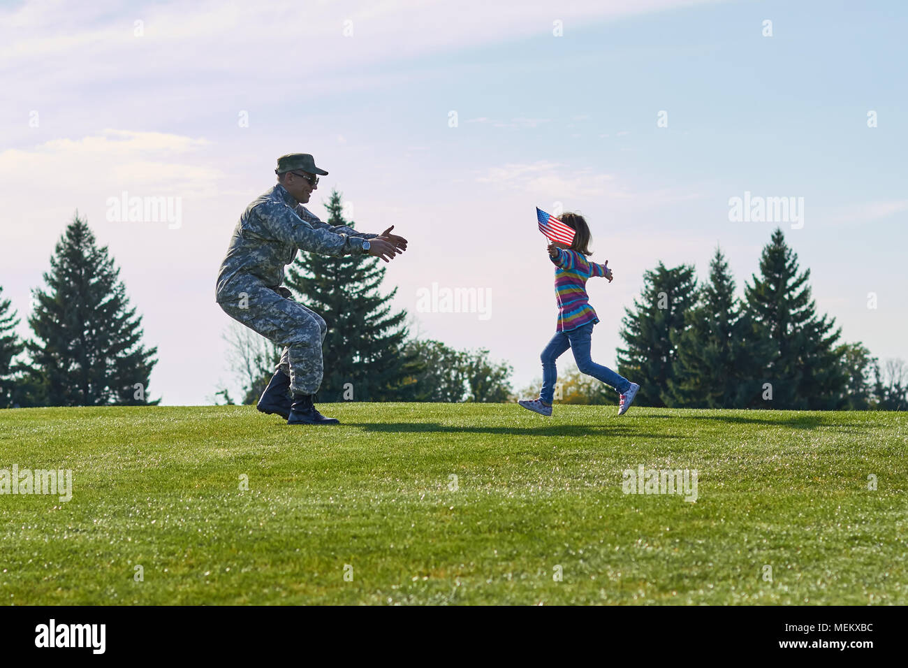 Girl running to her military father, side view Stock Photo - Alamy
