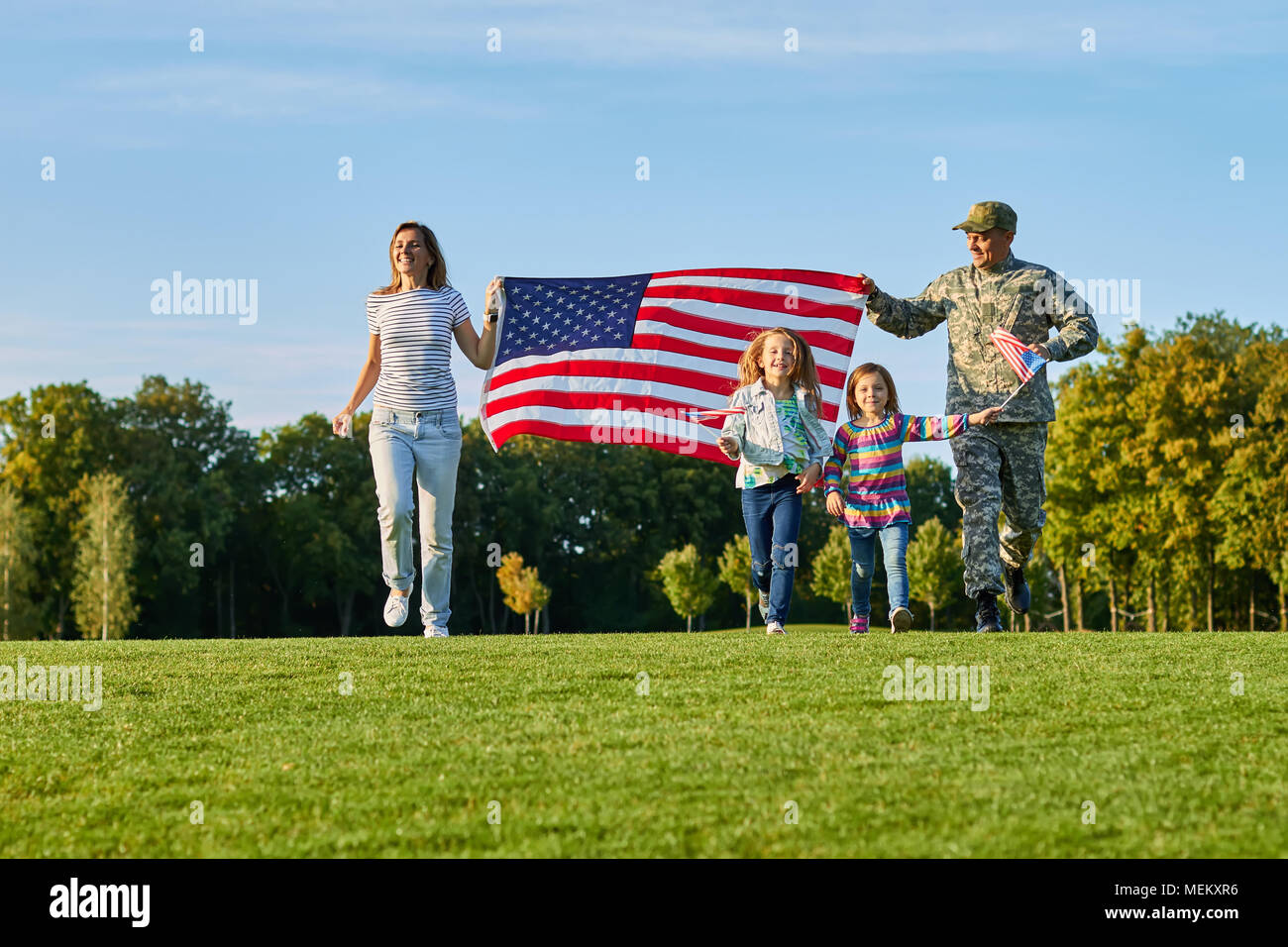 Soldier and his family are walking walking american flags Stock Photo ...