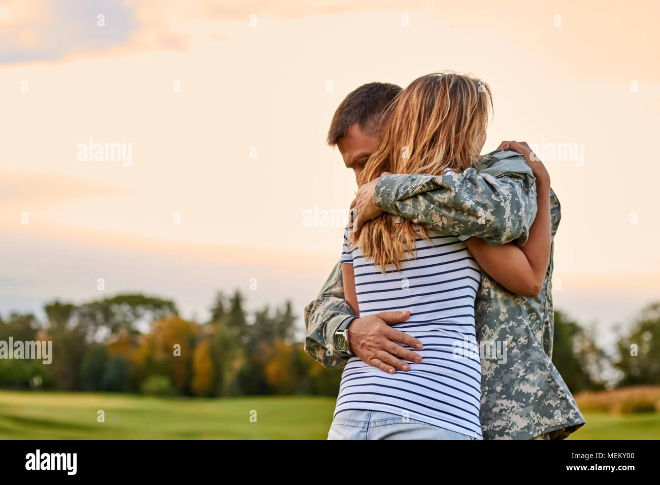 Soldier is hugging a woman outdoor Stock Photo - Alamy