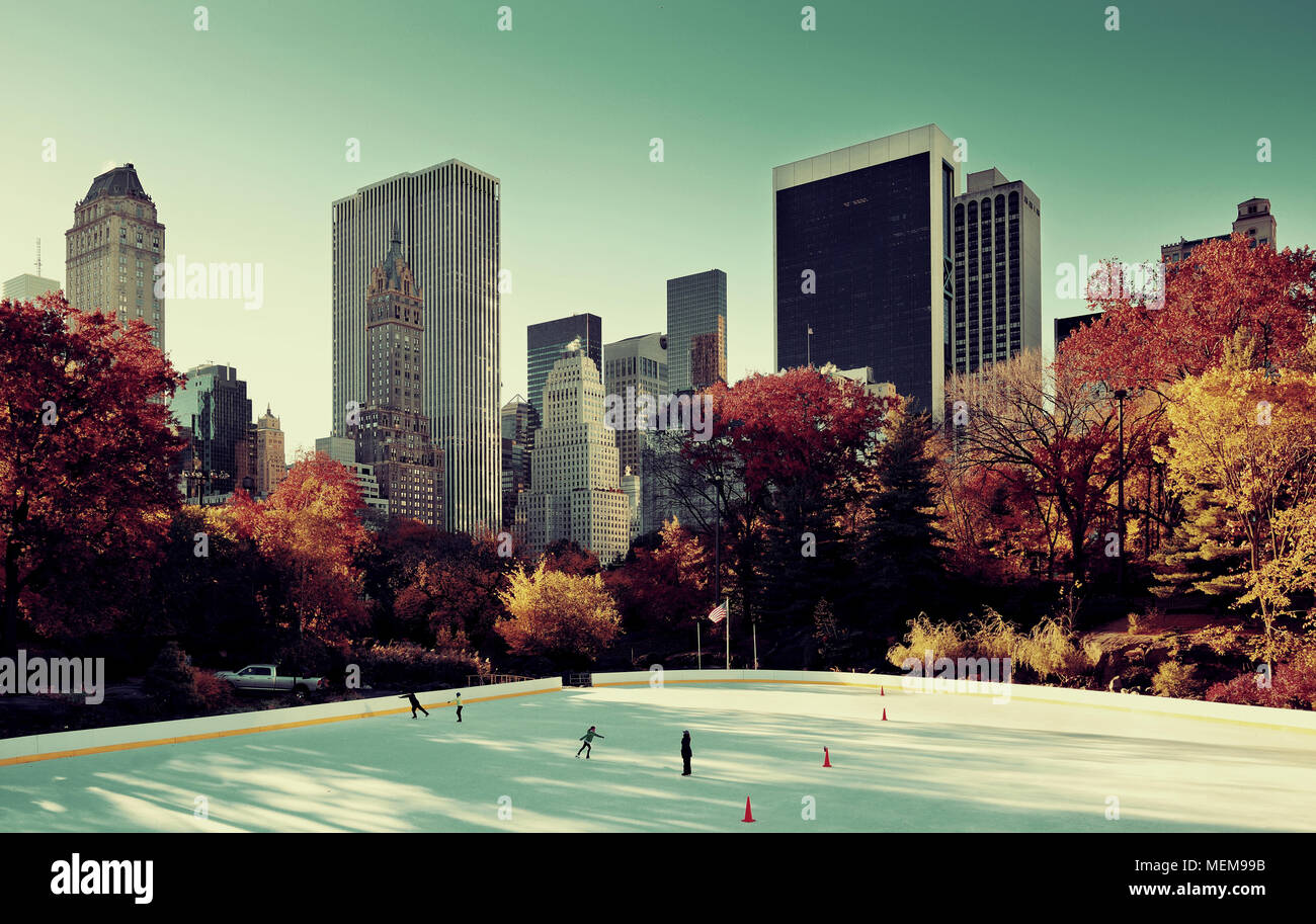 Central Park Autumn ice rink midtown skyline in Manhattan New York City ...