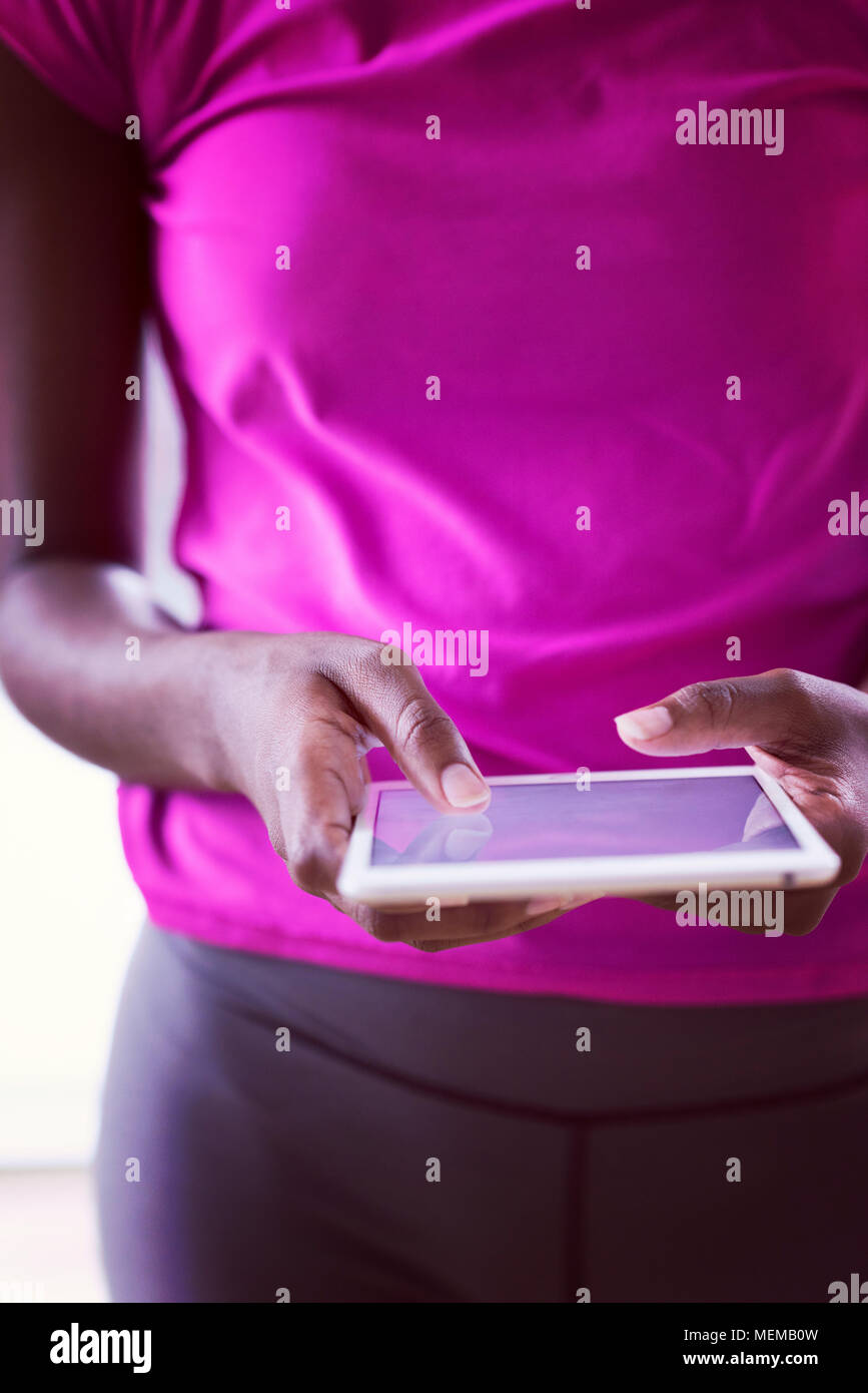 beautiful african american woman using tablet computer from home while ...