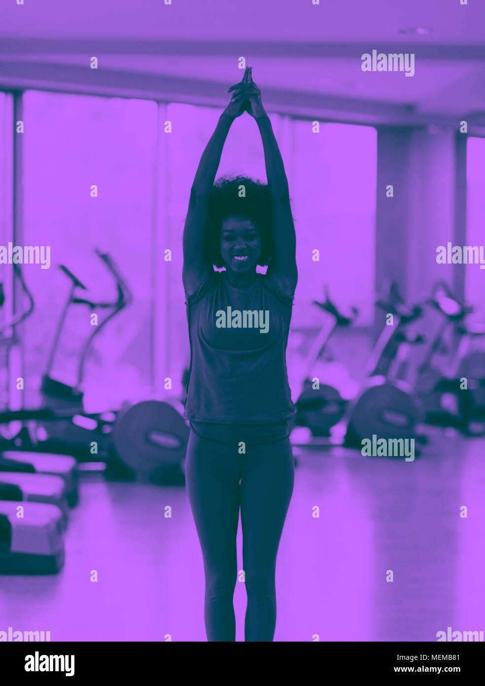 beautiful young african american woman exercise yoga in gym duo tone ...