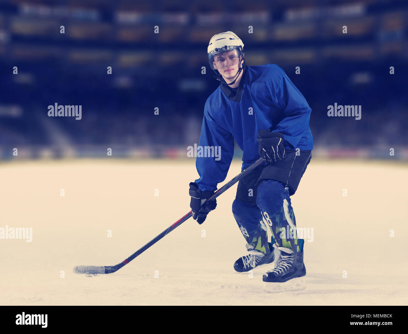 ice hockey player in action kicking with stick Stock Photo - Alamy