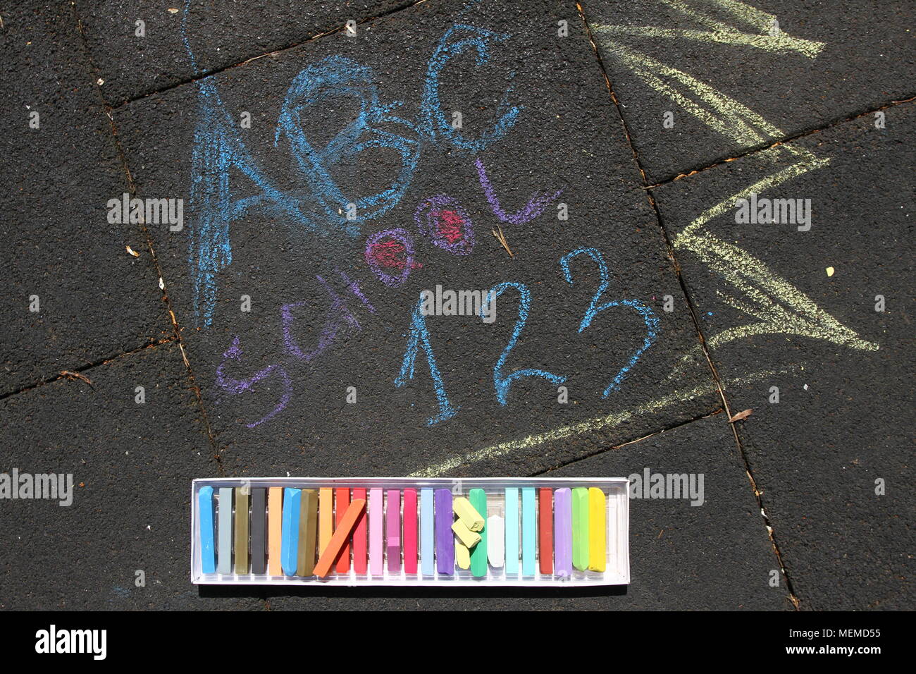 School, ABC and 123 sigh written with colored chalks on a pavement ...