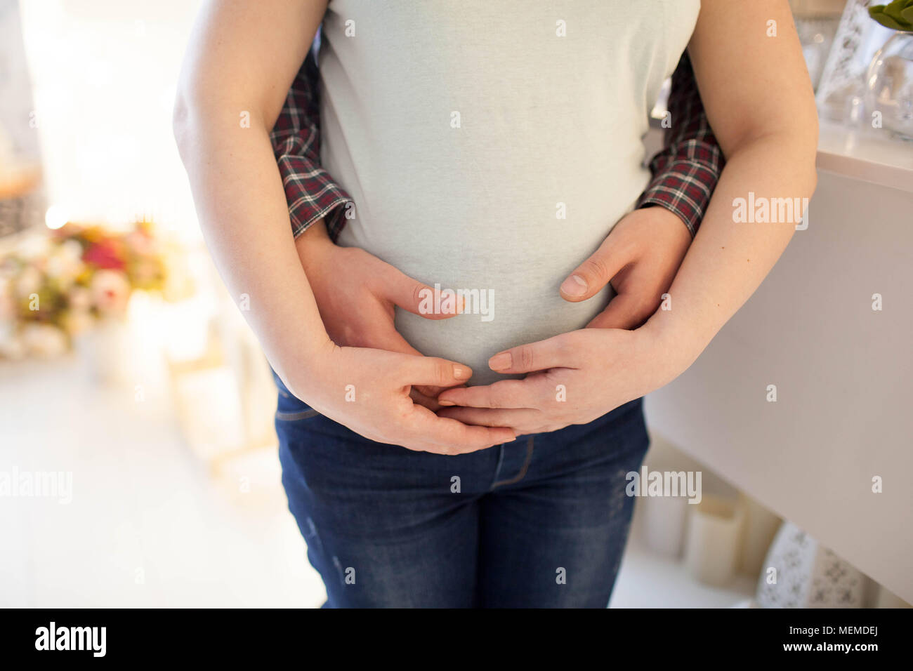 Young Pregnant Woman Holds Her Hands On Her Swollen Belly Love Concept