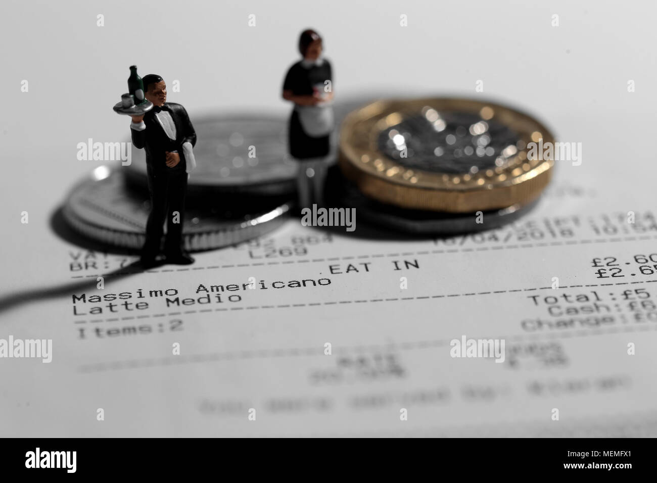 Miniature scale model waiter and waitress on a till receipt bill with ...