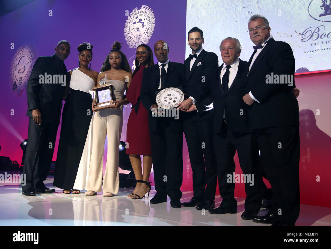 Family members collect the PFA Merit Award after it is awarded ...
