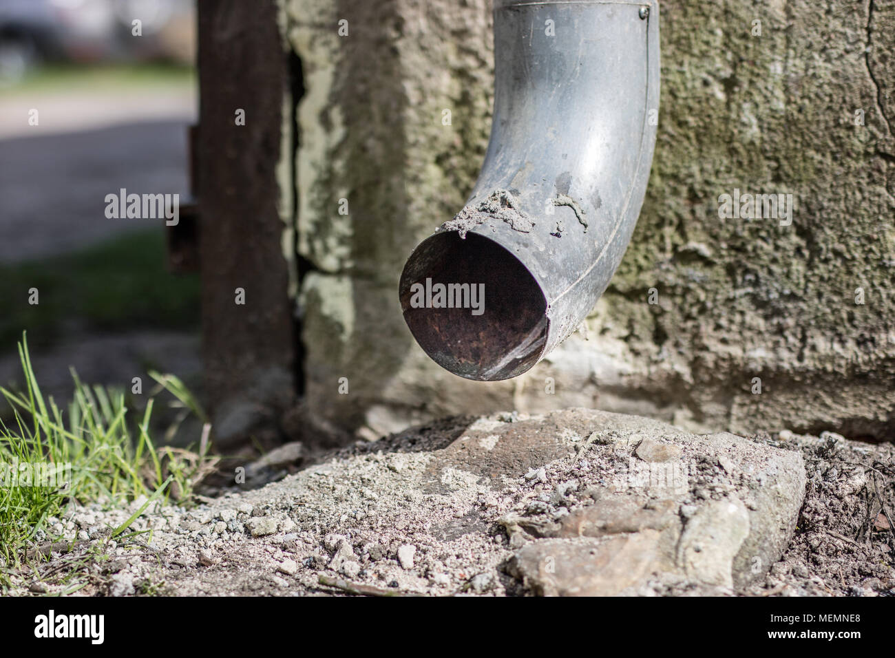 A gutter mounted on the wall of the building. Gutter spout in single ...
