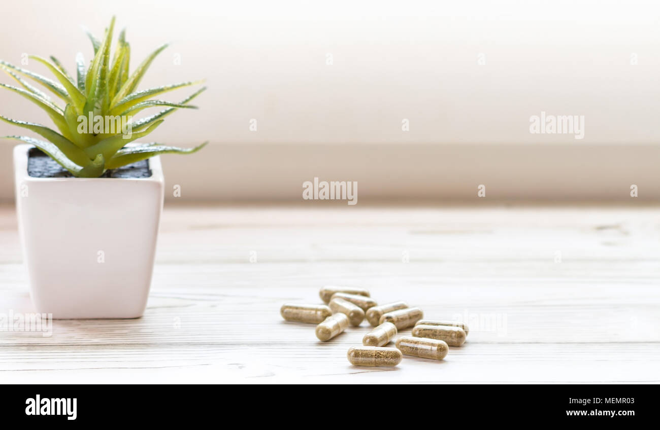 Group of clear CBD Cannabidiol capsules on bright wooden backdrop Stock ...