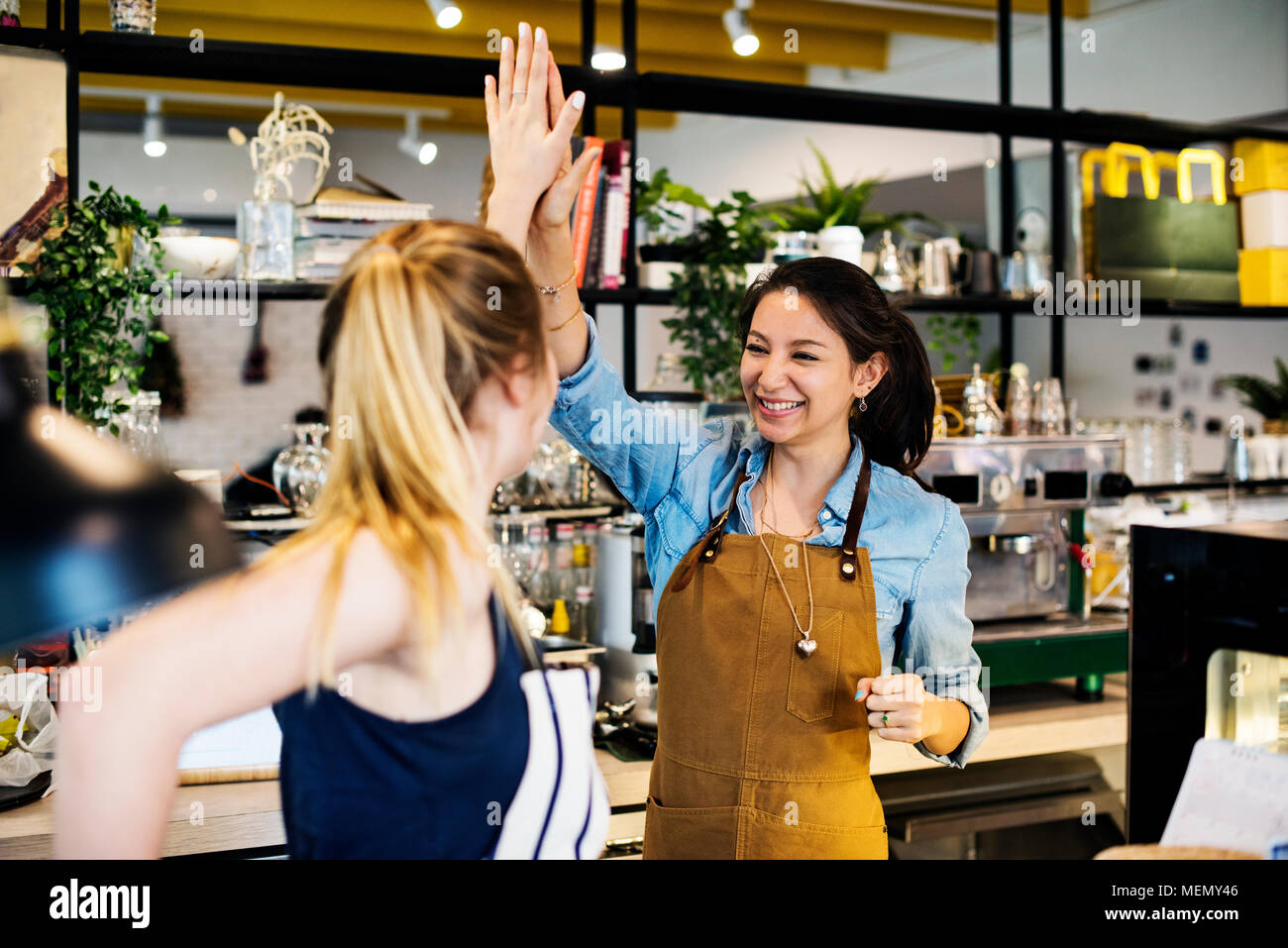 Women give a high five to each other Stock Photo - Alamy