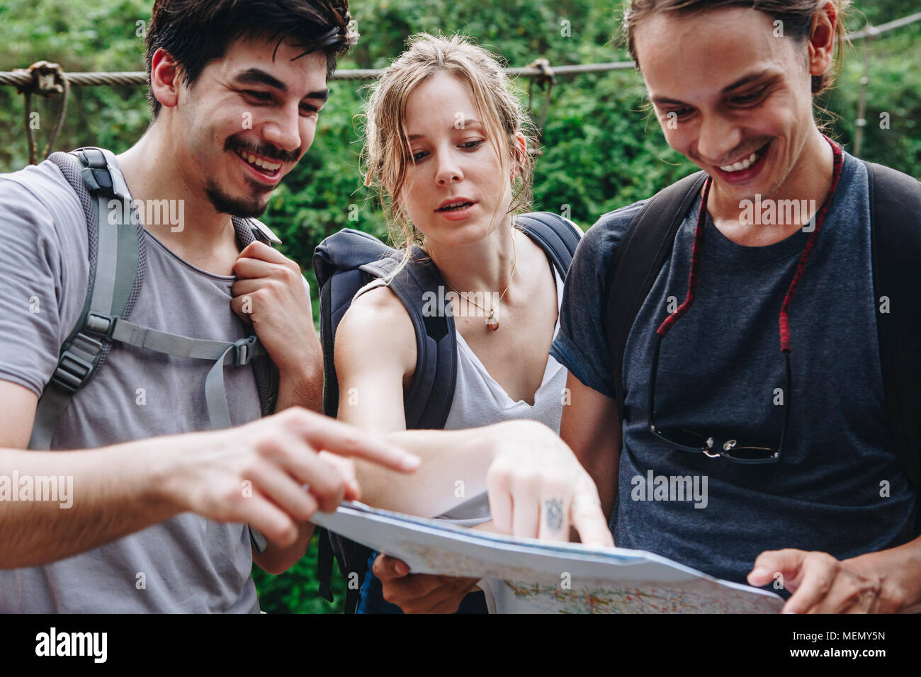 Friends finding their way with a map Stock Photo - Alamy
