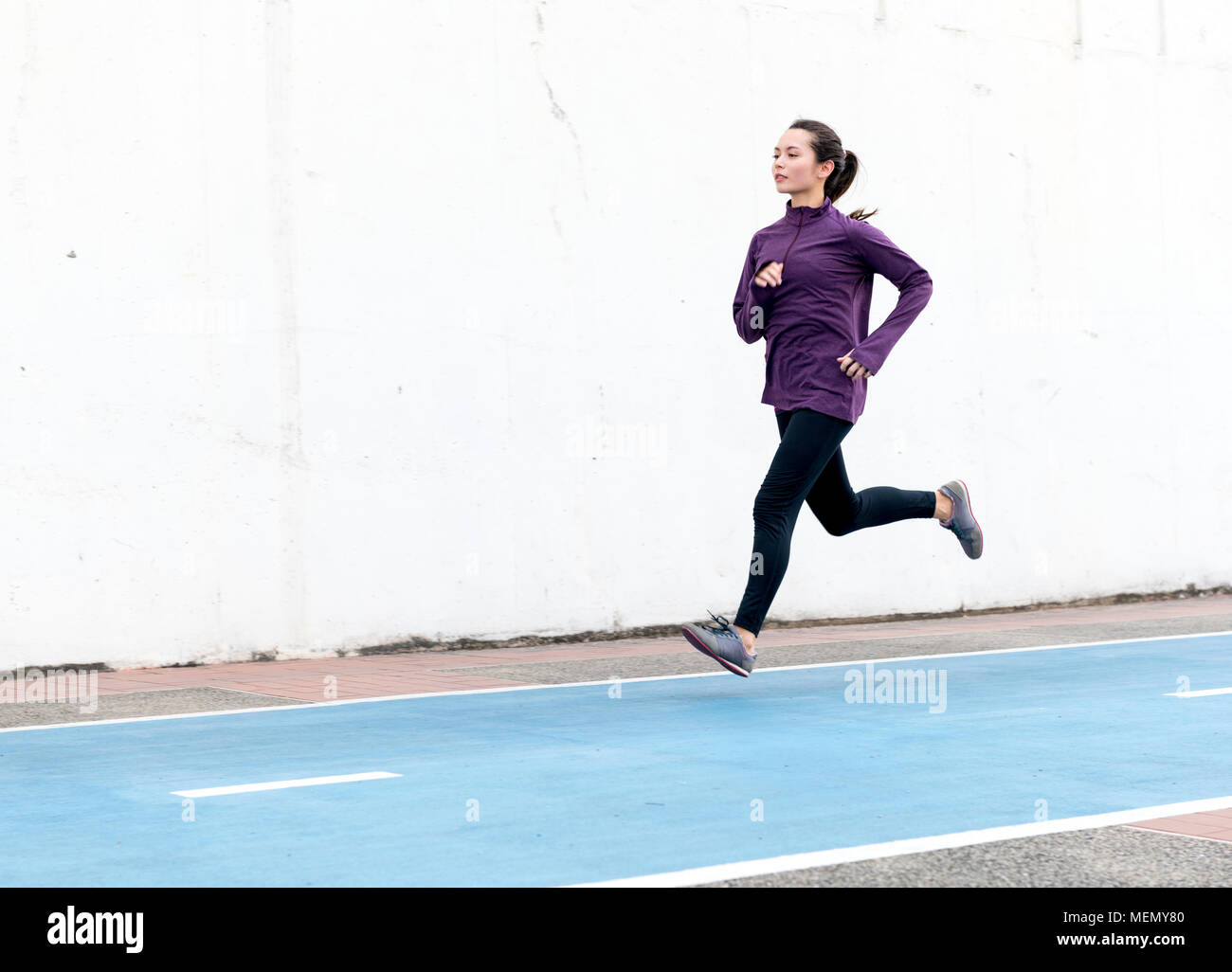 White woman running on track Stock Photo - Alamy