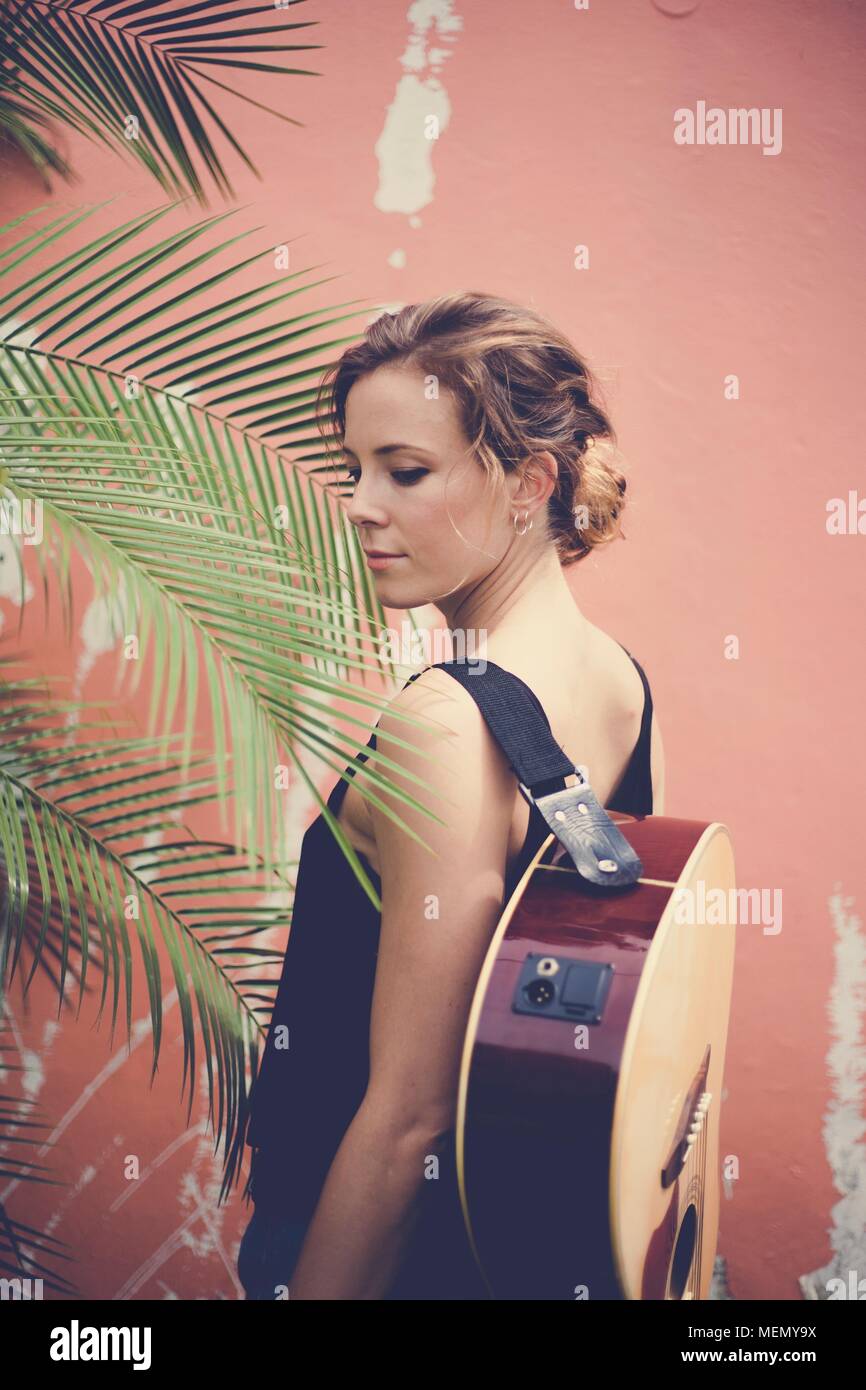 Beautiful guitarist woman with guitar classic Stock Photo - Alamy