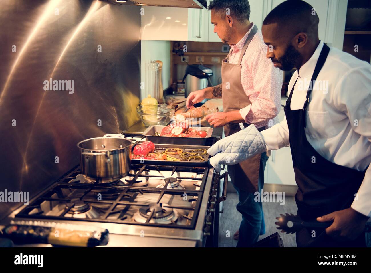Two men cooking in a kitchen Stock Photo - Alamy