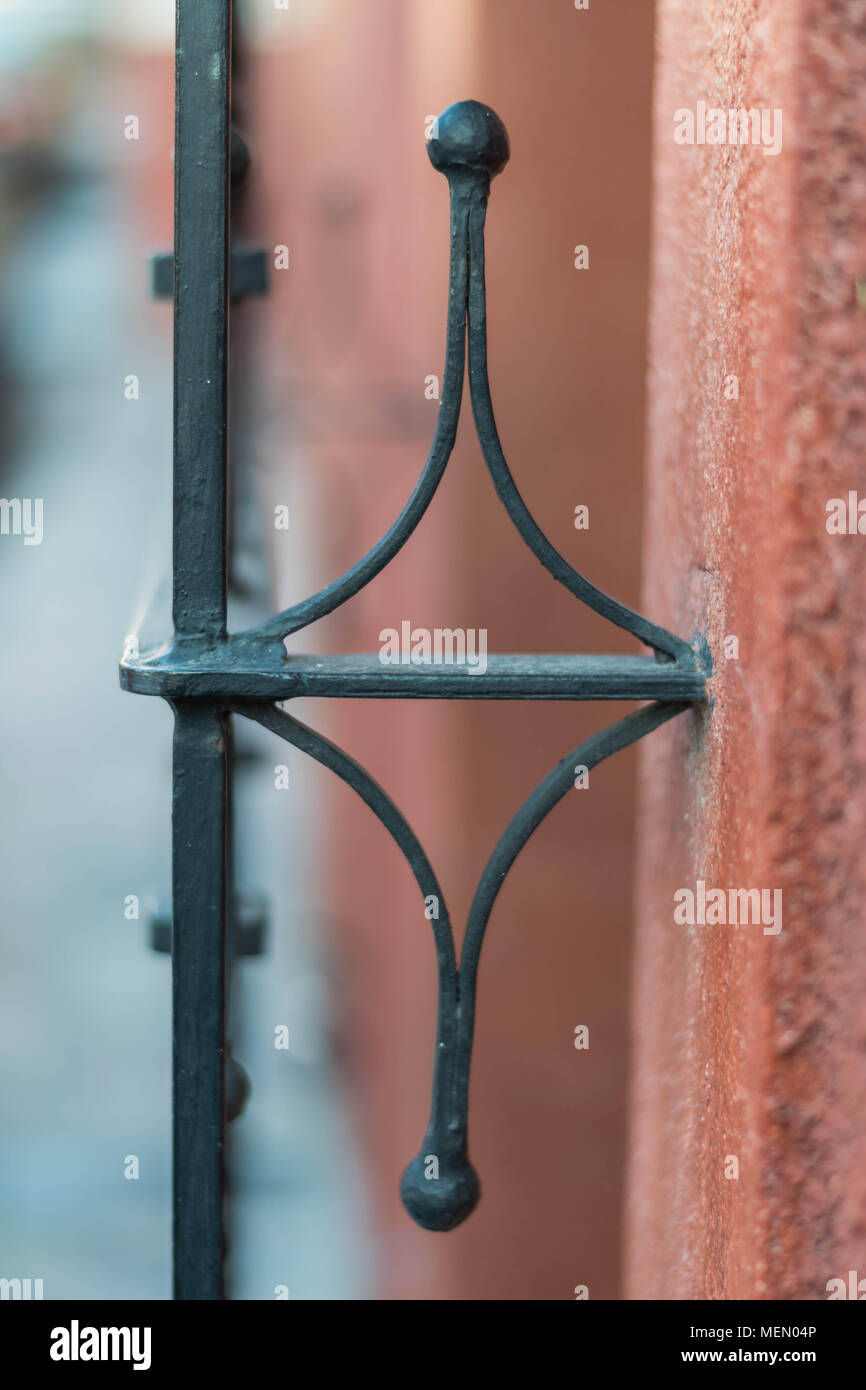 Decorative side piece of window bars in black iron, up-close and ...