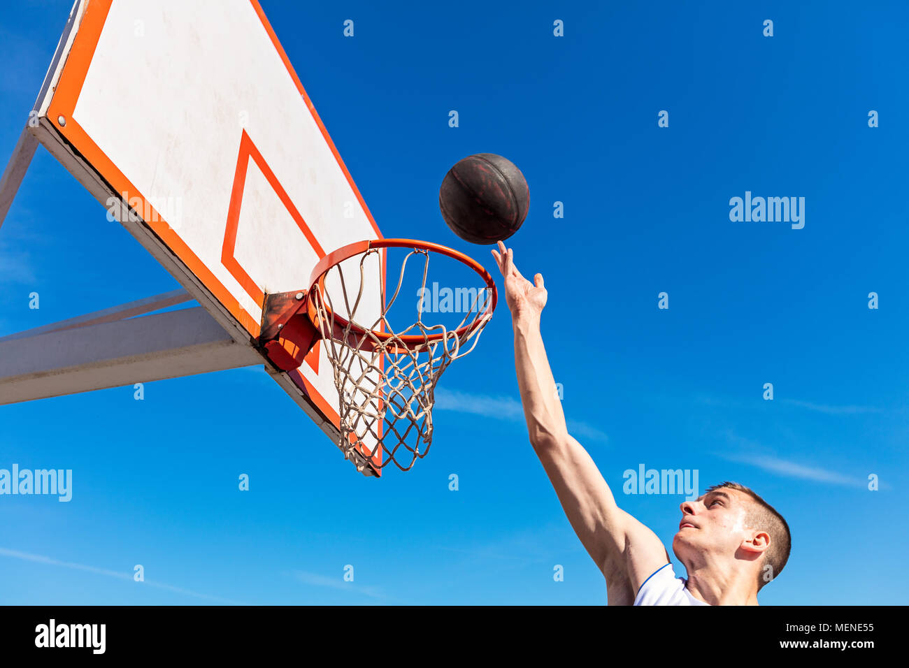 Slam Dunk. Side view of young basketball player making slam dunk Stock ...
