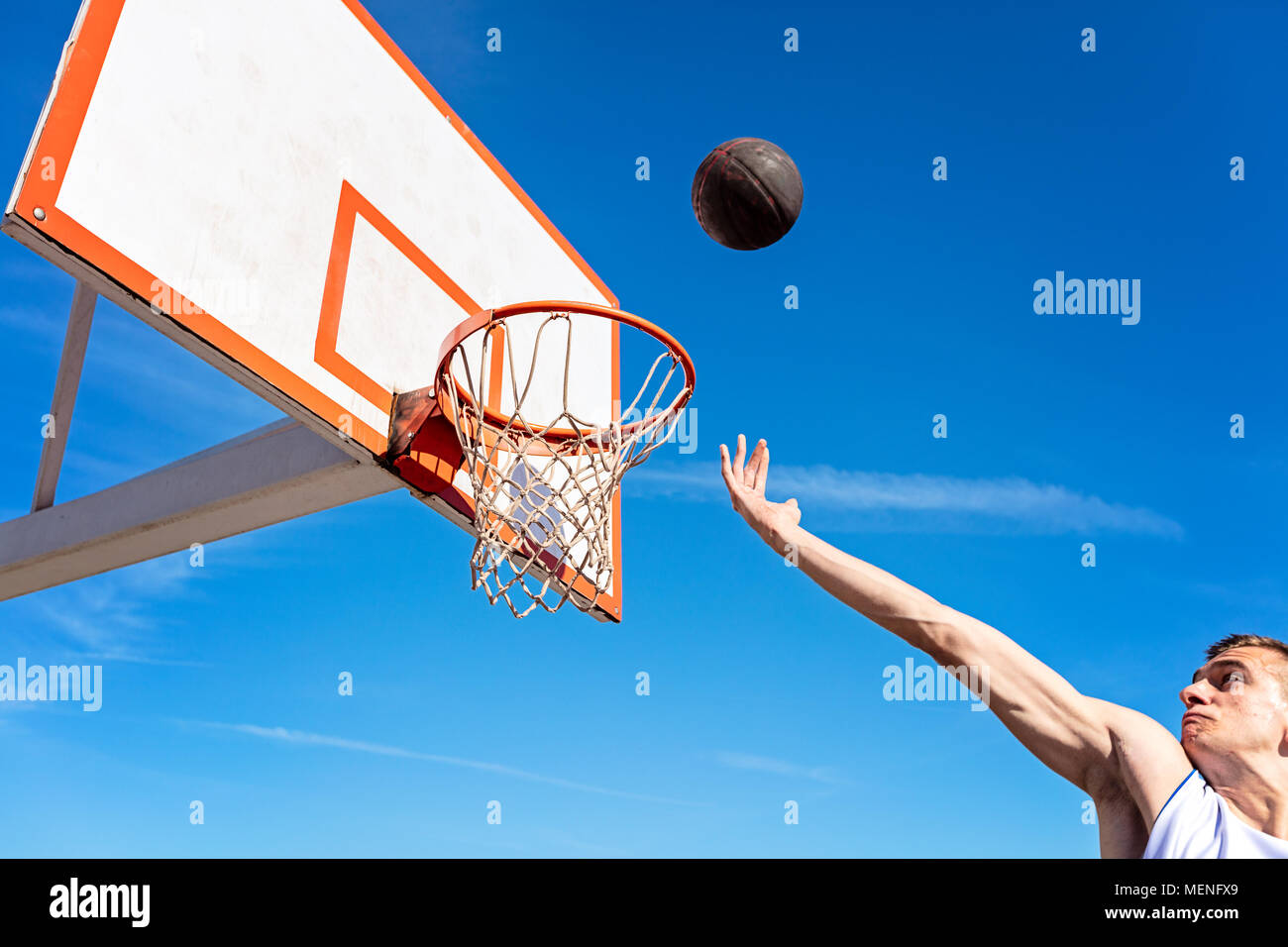 Slam Dunk. Side view of young basketball player making slam dunk Stock ...