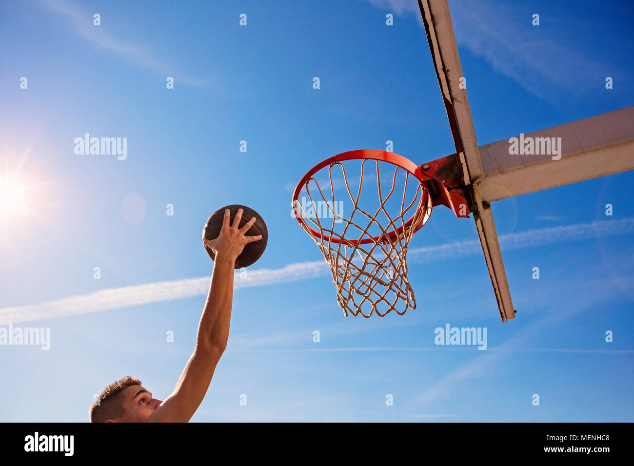 Slam Dunk. Side view of young basketball player making slam dunk Stock ...