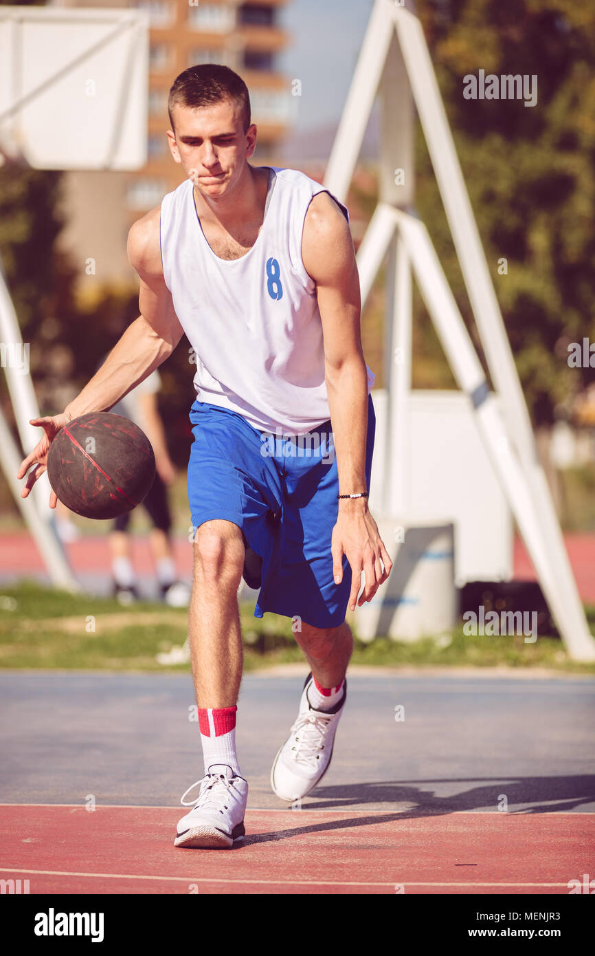 Handsome male playing basketball outdoor Stock Photo - Alamy