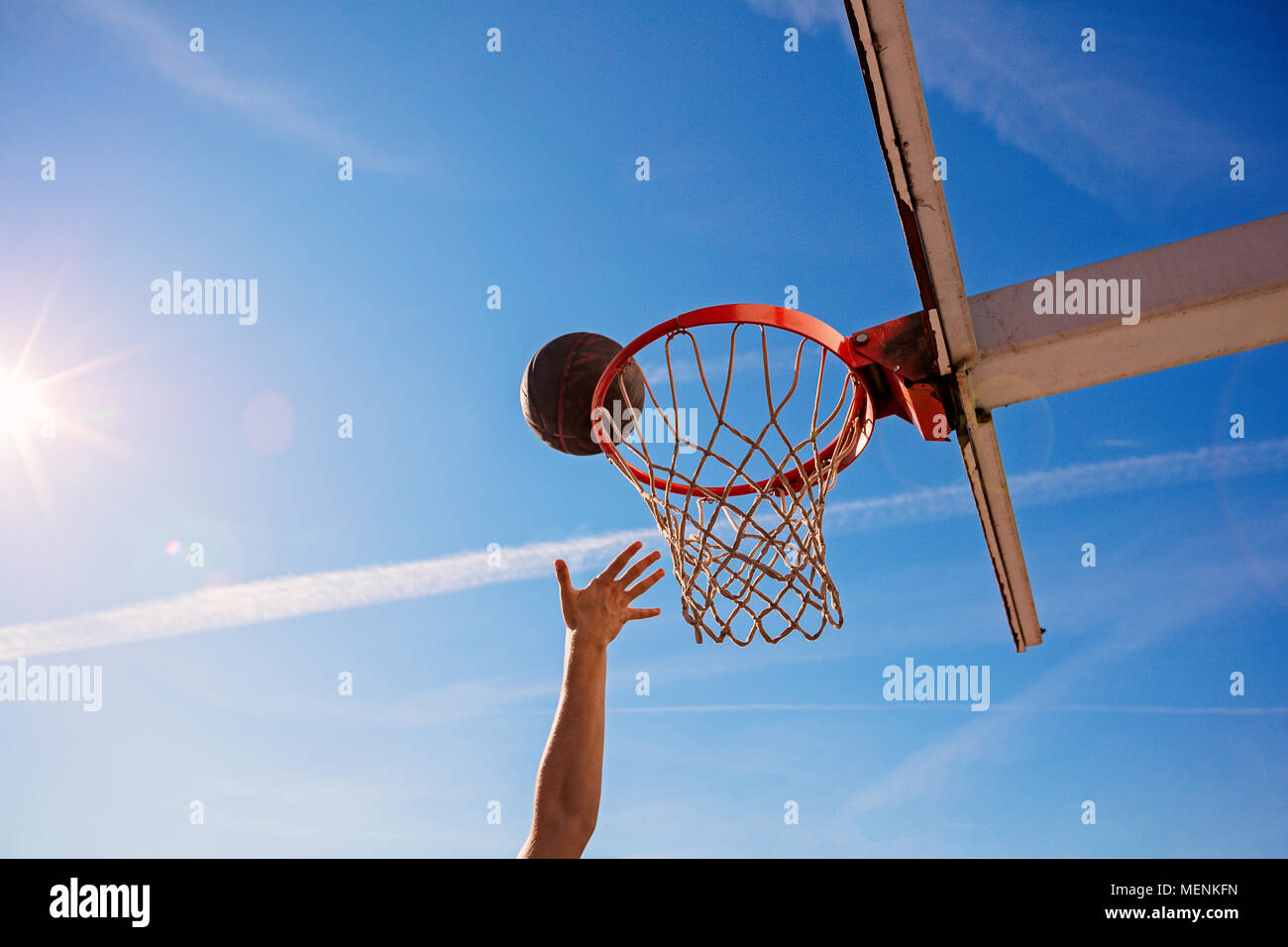 Slam Dunk. Side view of young basketball player making slam dunk Stock ...