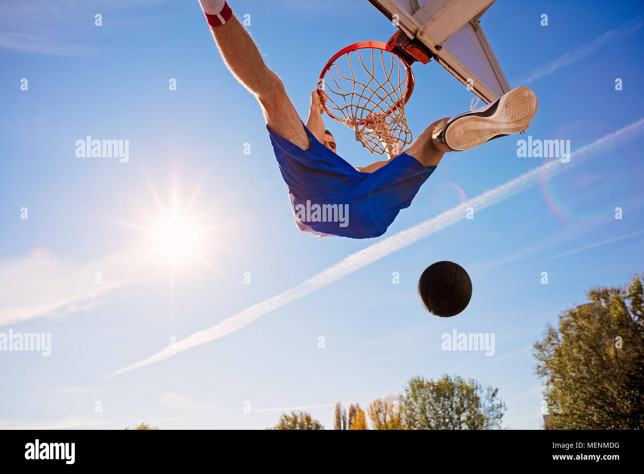 Slam Dunk. Side view of young basketball player making slam dunk Stock ...