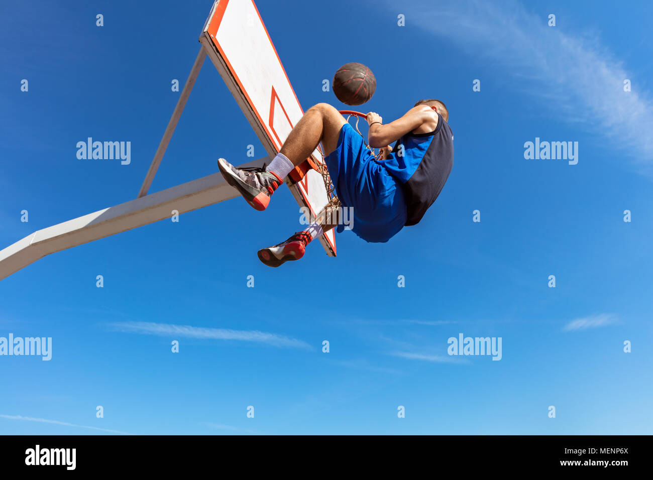 Slam Dunk. Side view of young basketball player making slam dunk Stock ...
