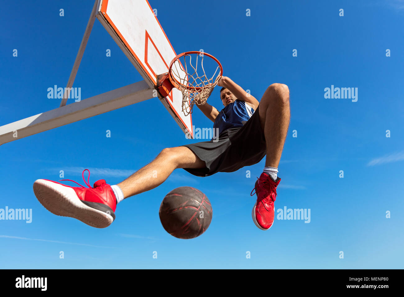 Slam Dunk. Side view of young basketball player making slam dunk Stock ...