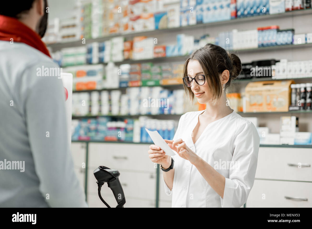 Pharmacist selling medications in the pharmacy store Stock Photo - Alamy