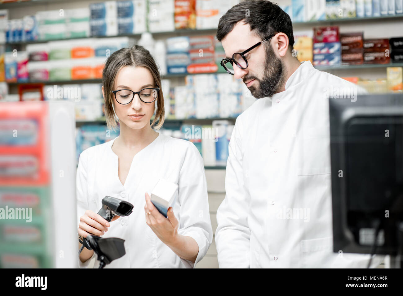 Pharmacists working in the pharmacy store Stock Photo - Alamy