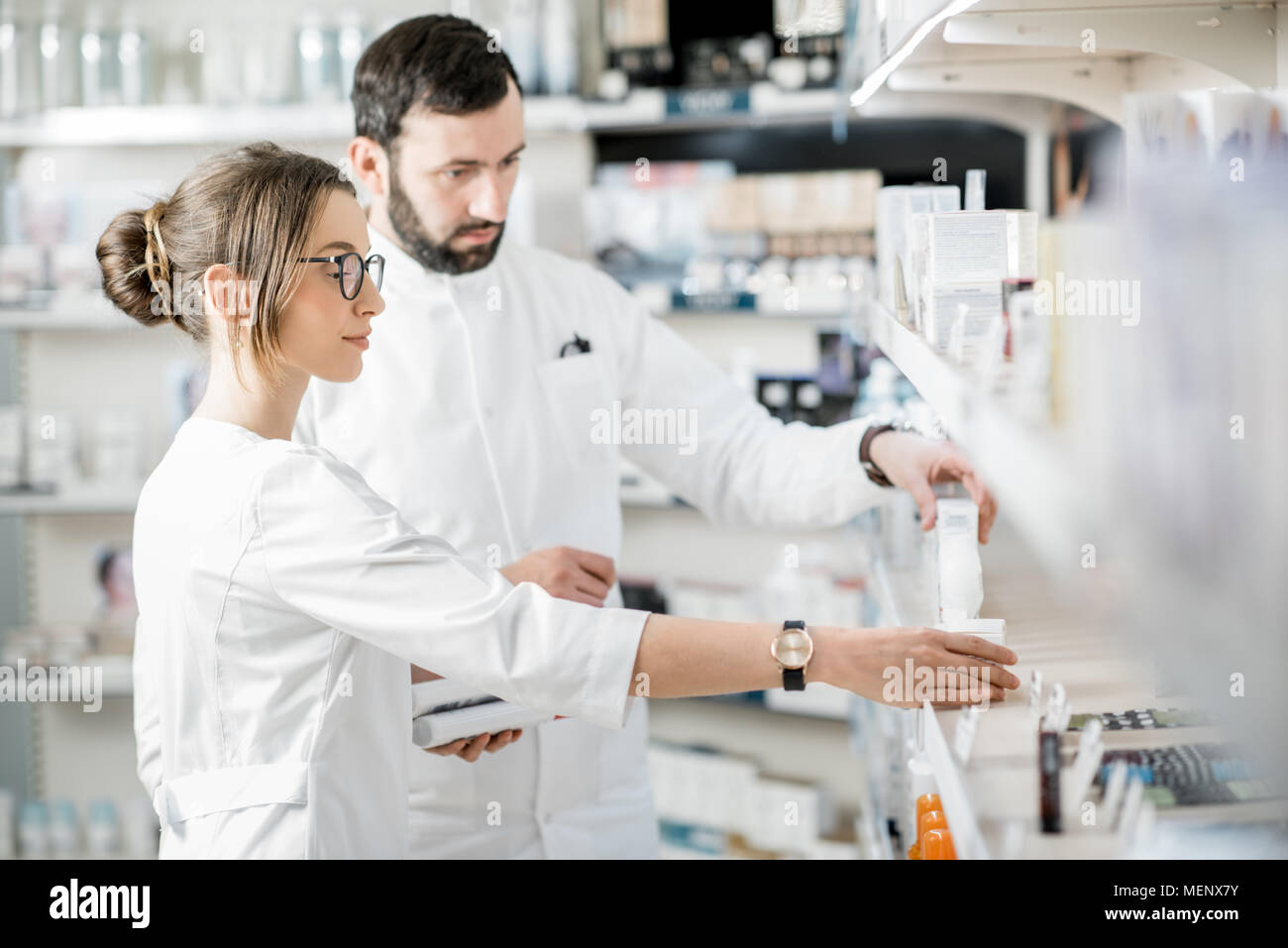 Pharmacists working in the pharmacy store Stock Photo - Alamy