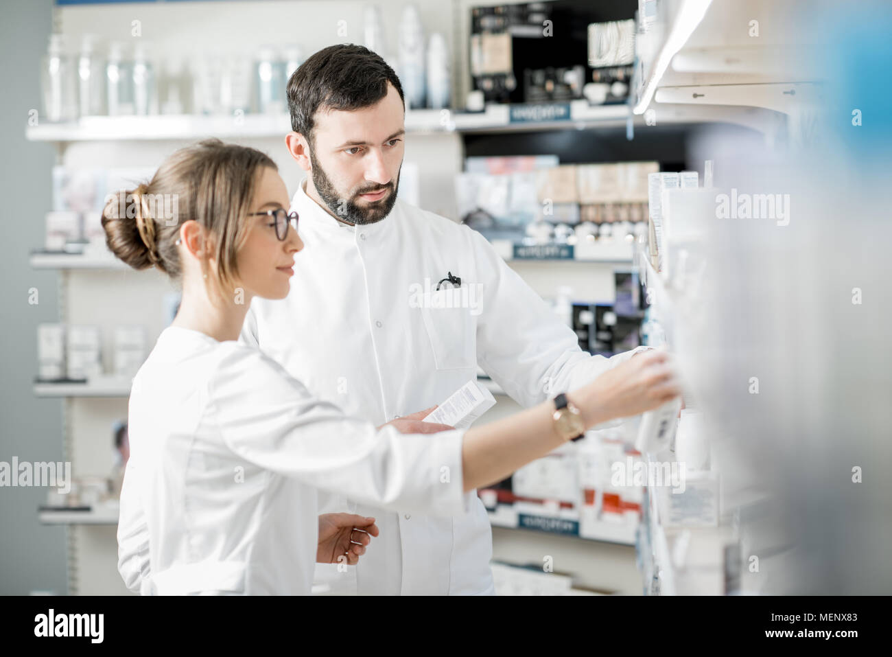Pharmacists working in the pharmacy store Stock Photo - Alamy