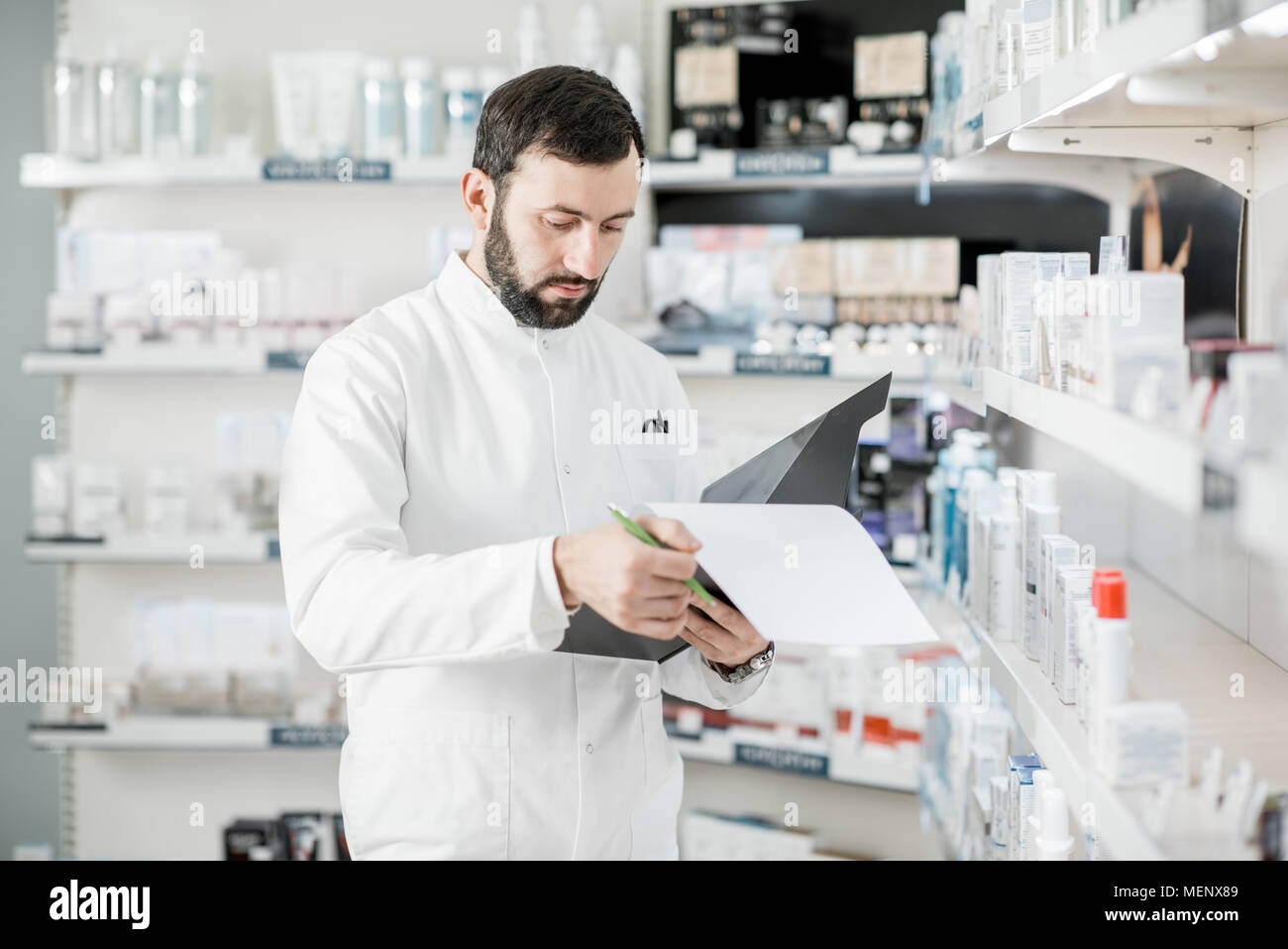 Pharmacists working in the pharmacy store Stock Photo - Alamy