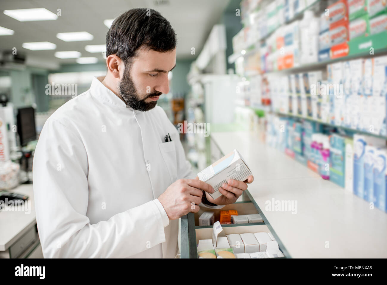 Pharmacist working in the pharmacy store Stock Photo - Alamy
