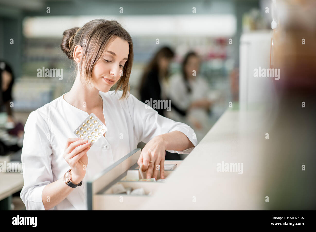 Pharmacist working in the pharmacy store Stock Photo - Alamy
