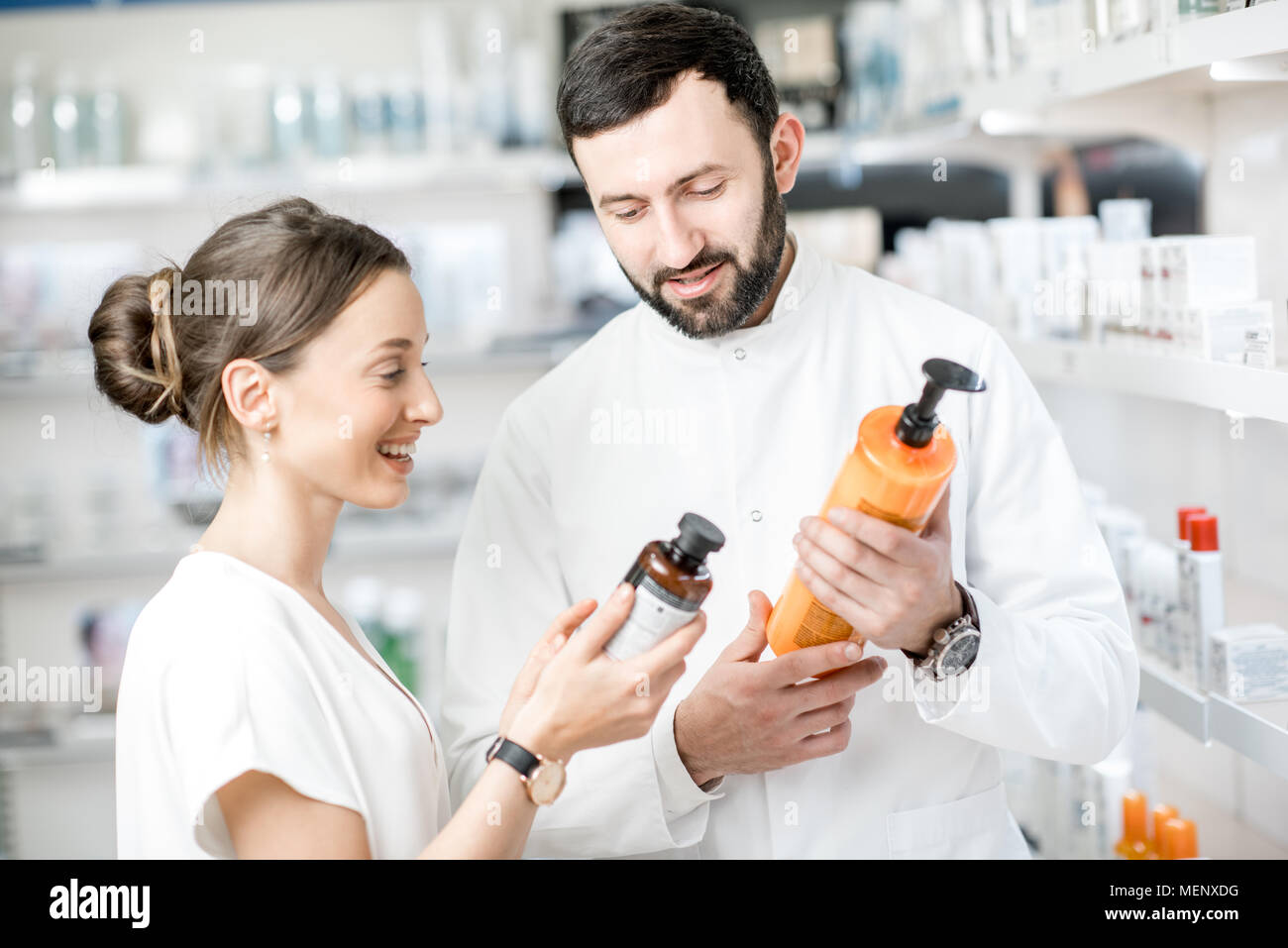 Pharmacist with client in the pharmacy store Stock Photo - Alamy