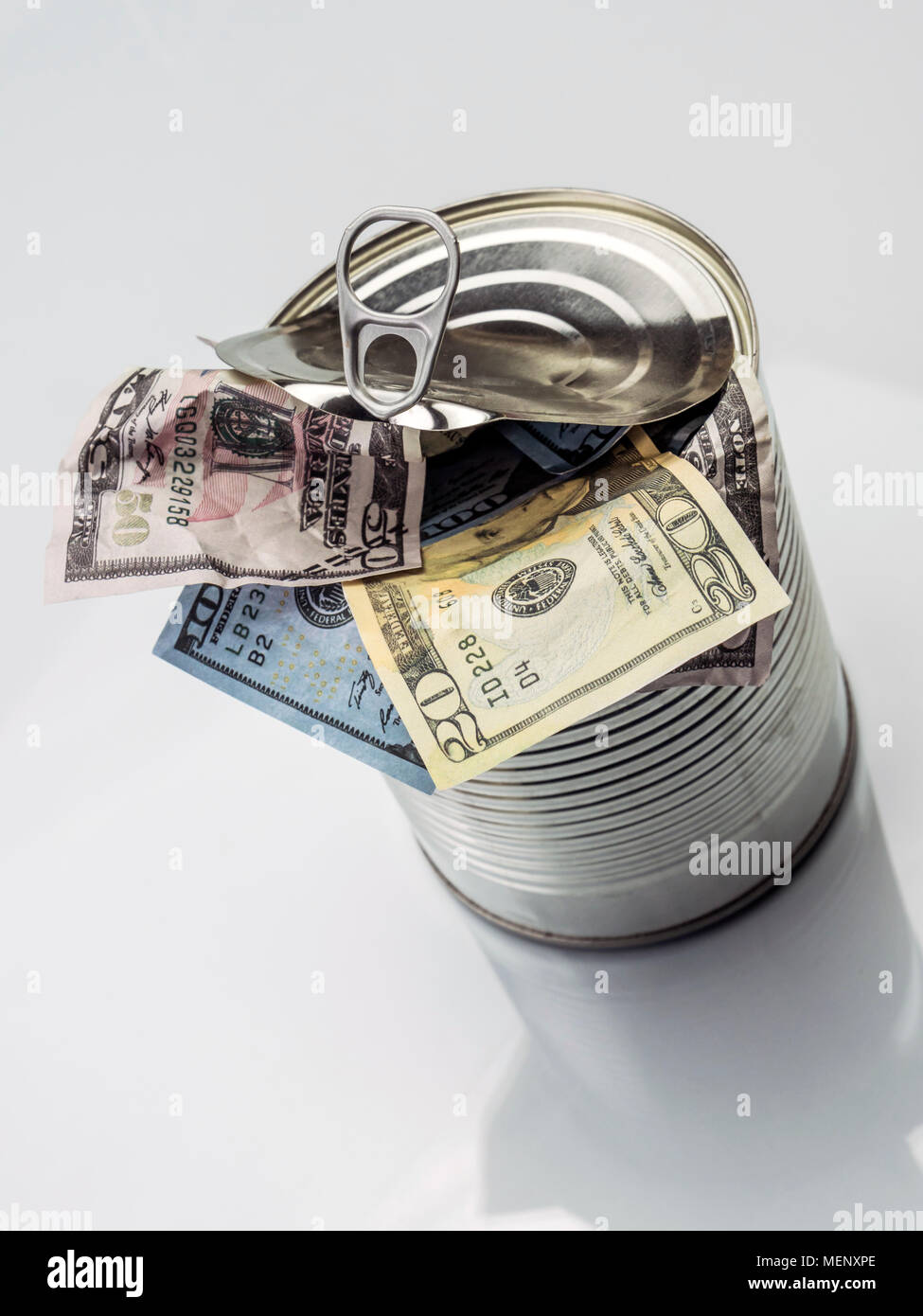 Canned cans full of dollar bills, conceptual image isolated on white ...