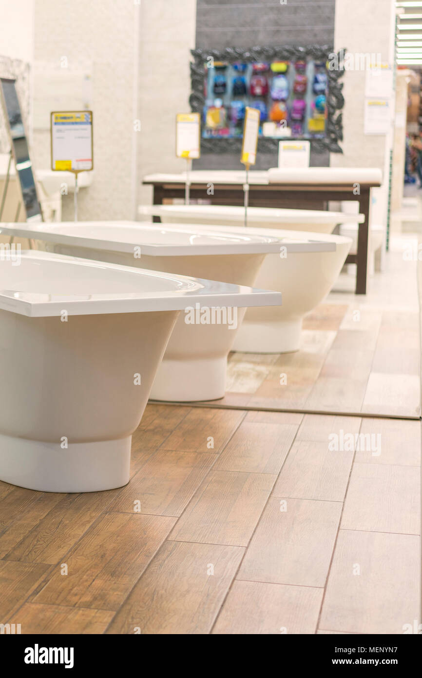 baths in the plumbing store. Sanitary engineering shop. White bathrooms ...