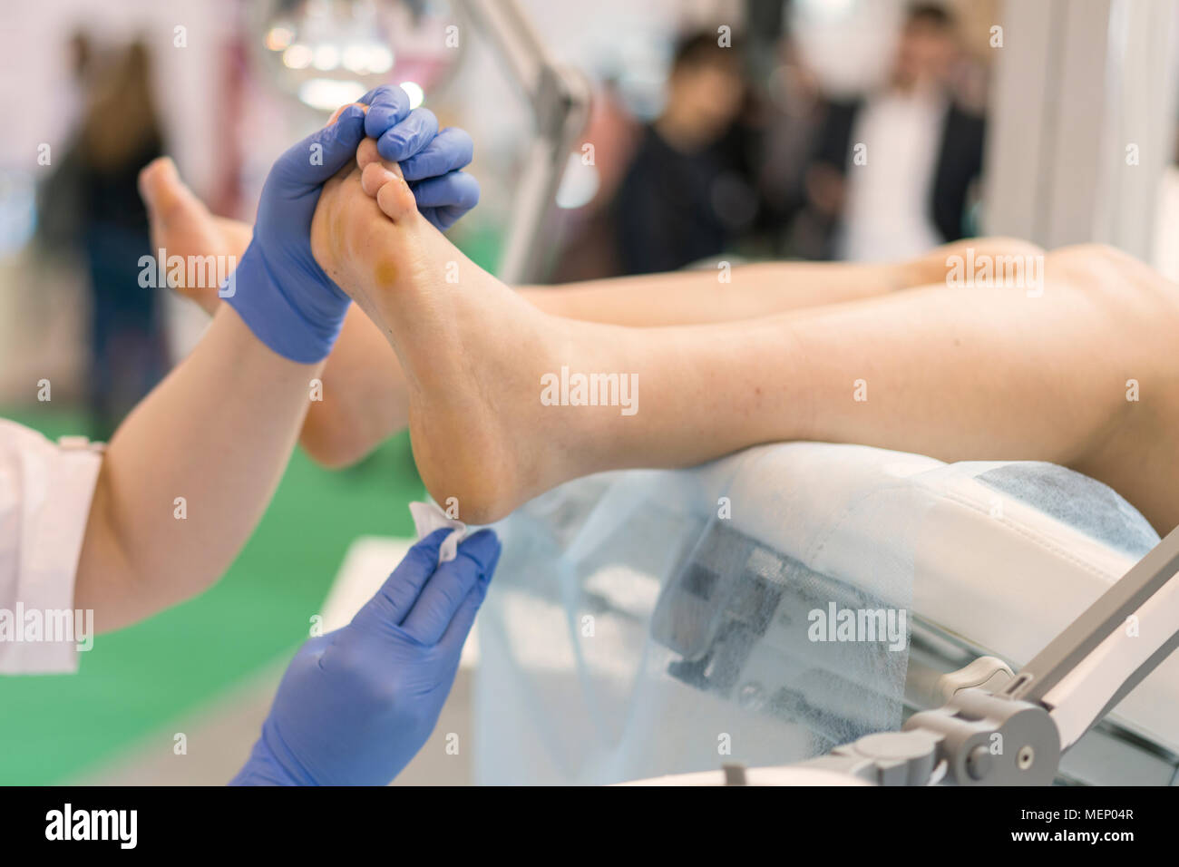 pretty doctor examining an elderly patient's foot Stock Photo - Alamy