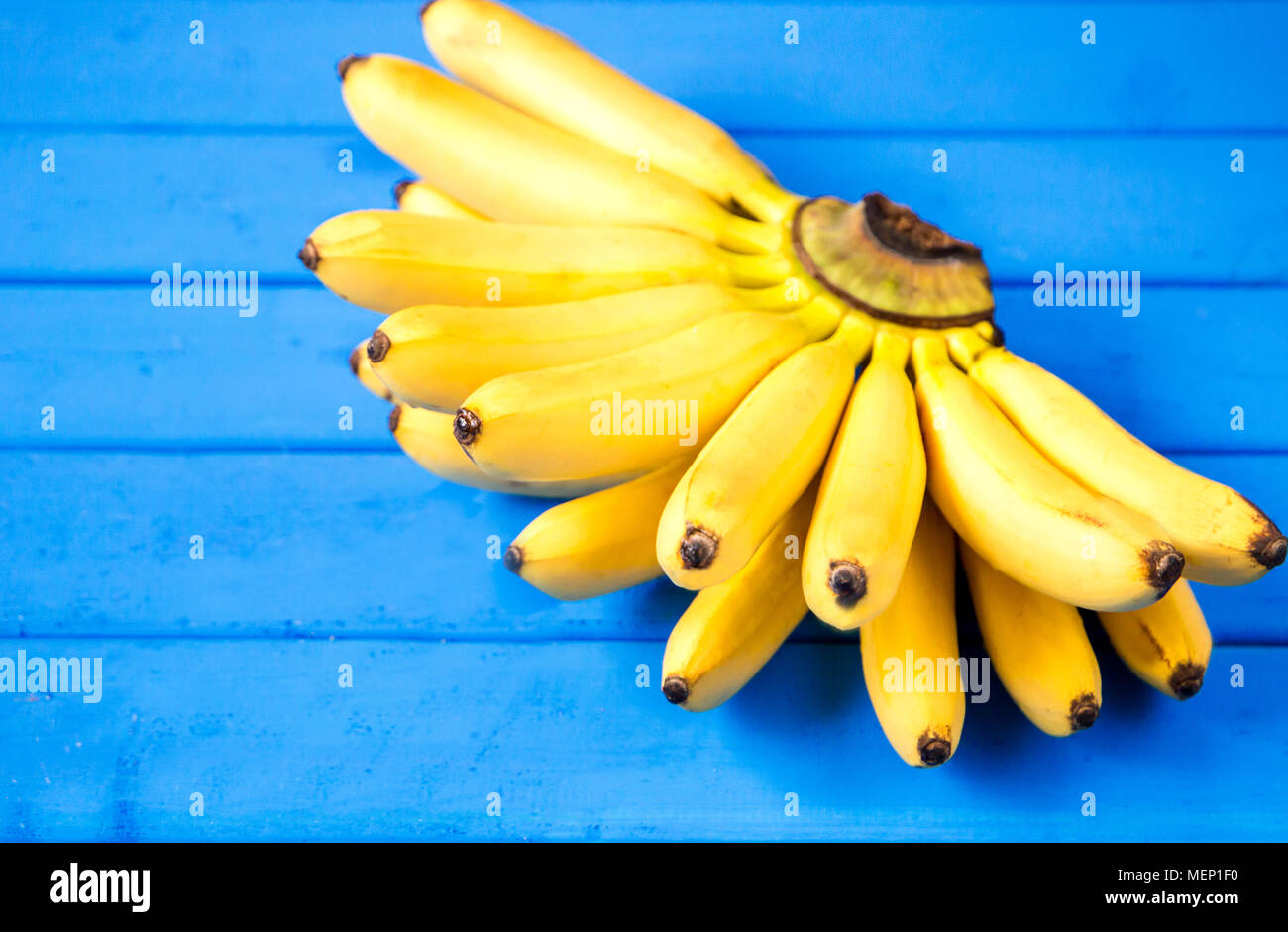 Raw Organic Yellow Baby Bananas in a Bunch Stock Photo - Alamy