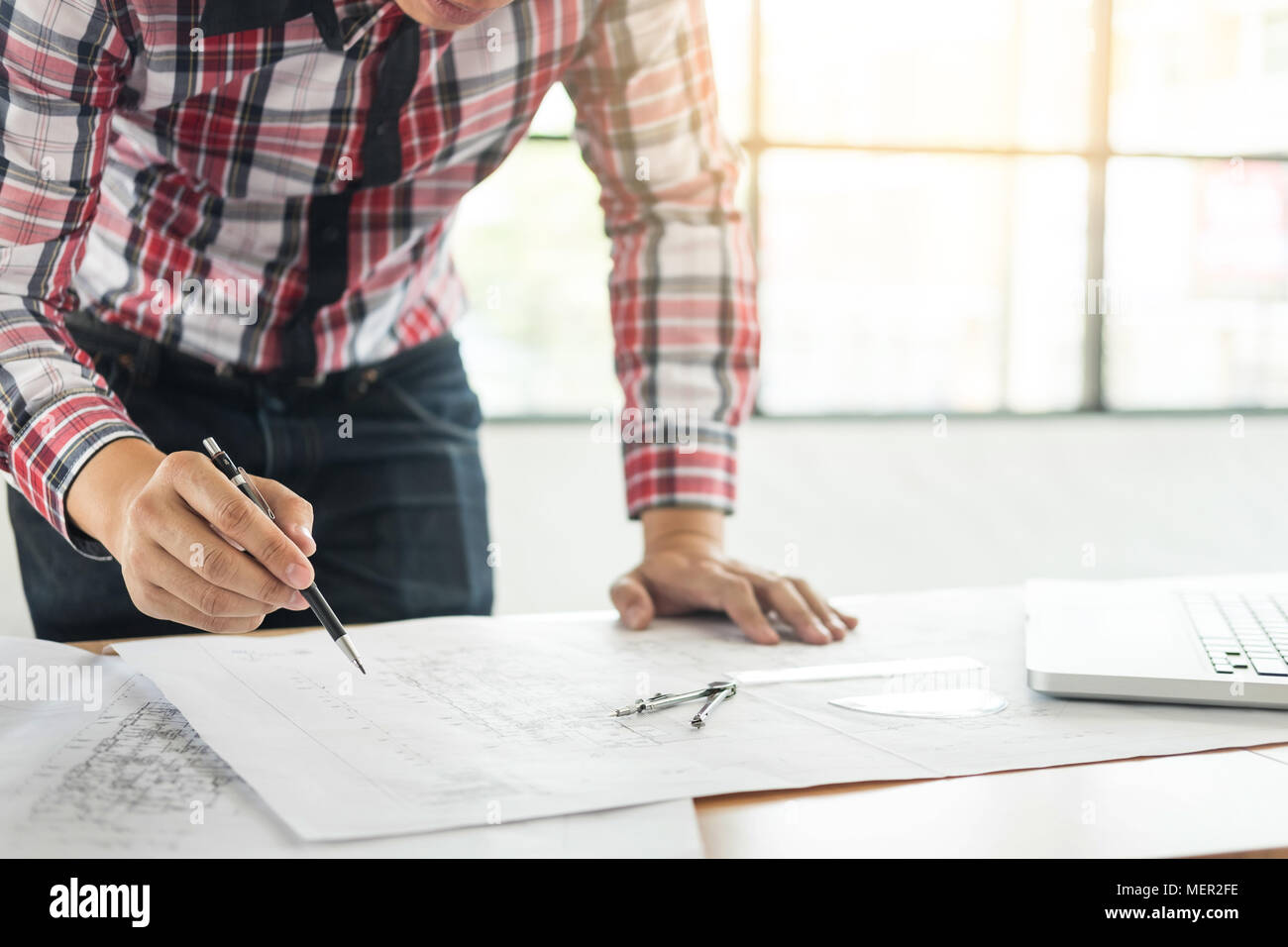 Person's engineer Hand Drawing Plan On Blue Print with architect ...